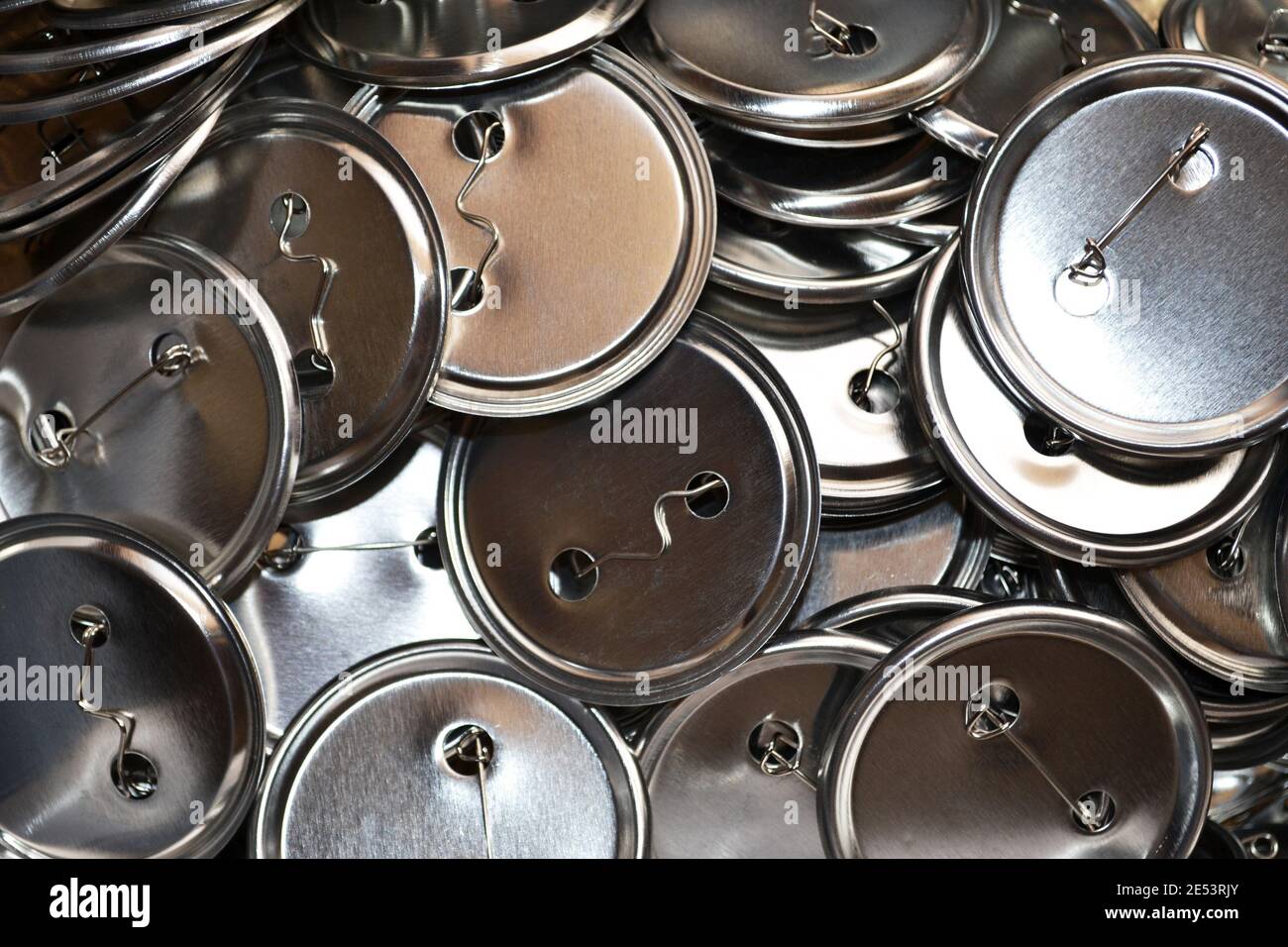 A pile of rounded button badges back parts with pins Stock Photo - Alamy