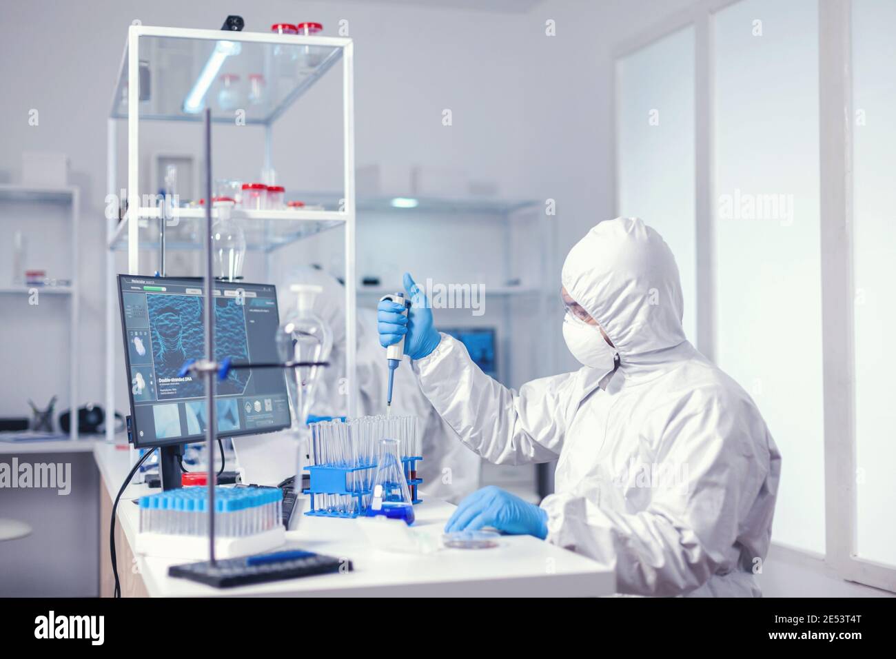 Researcher testing liquid sample uses micropipette in medical lab ...