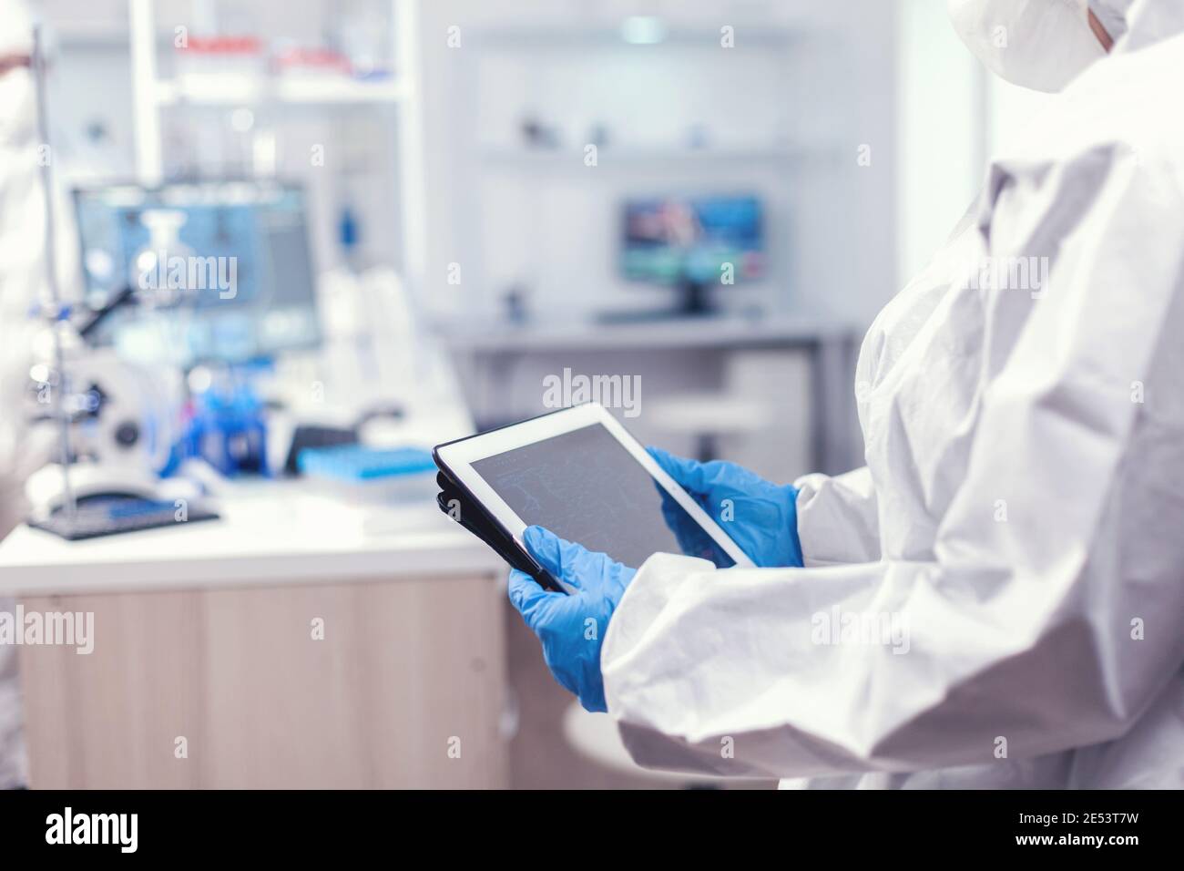 Team scientists in coverall researching hi-res stock photography and ...