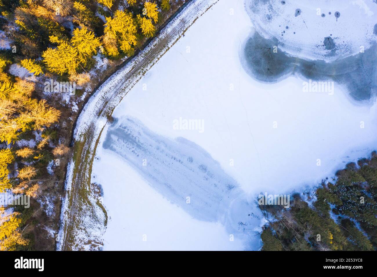 Aerial view of frozen lake. Aerial photography during winter season ...