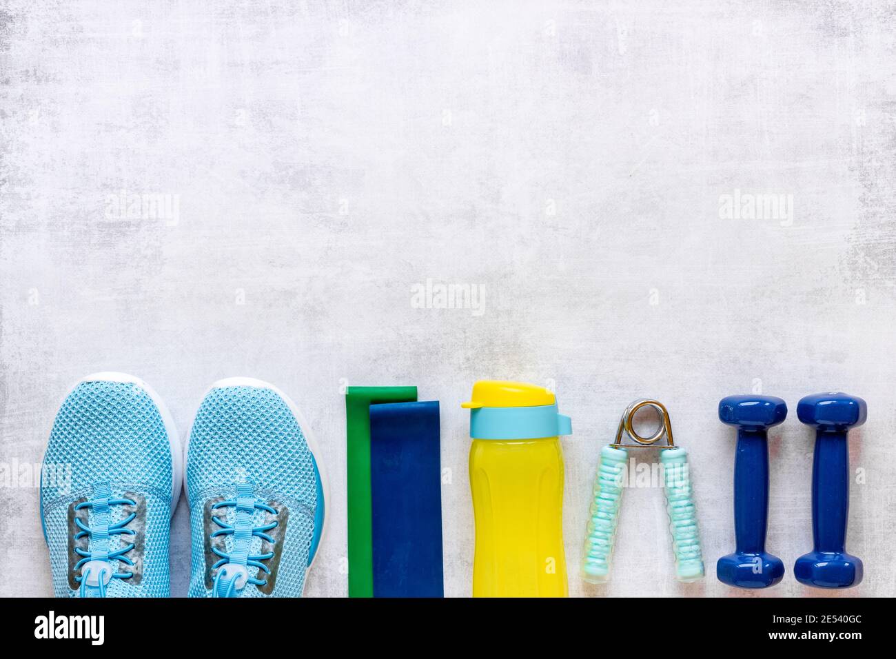 Fitness and gym equipment with sneakers and dumbbells. Sport background ...