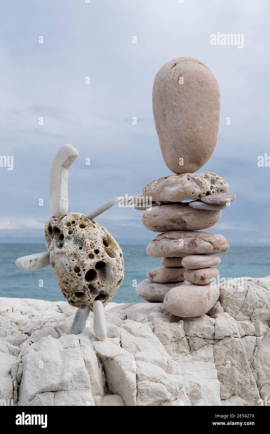 Vertical shot of balanced rocks artworks on the beach Stock Photo - Alamy