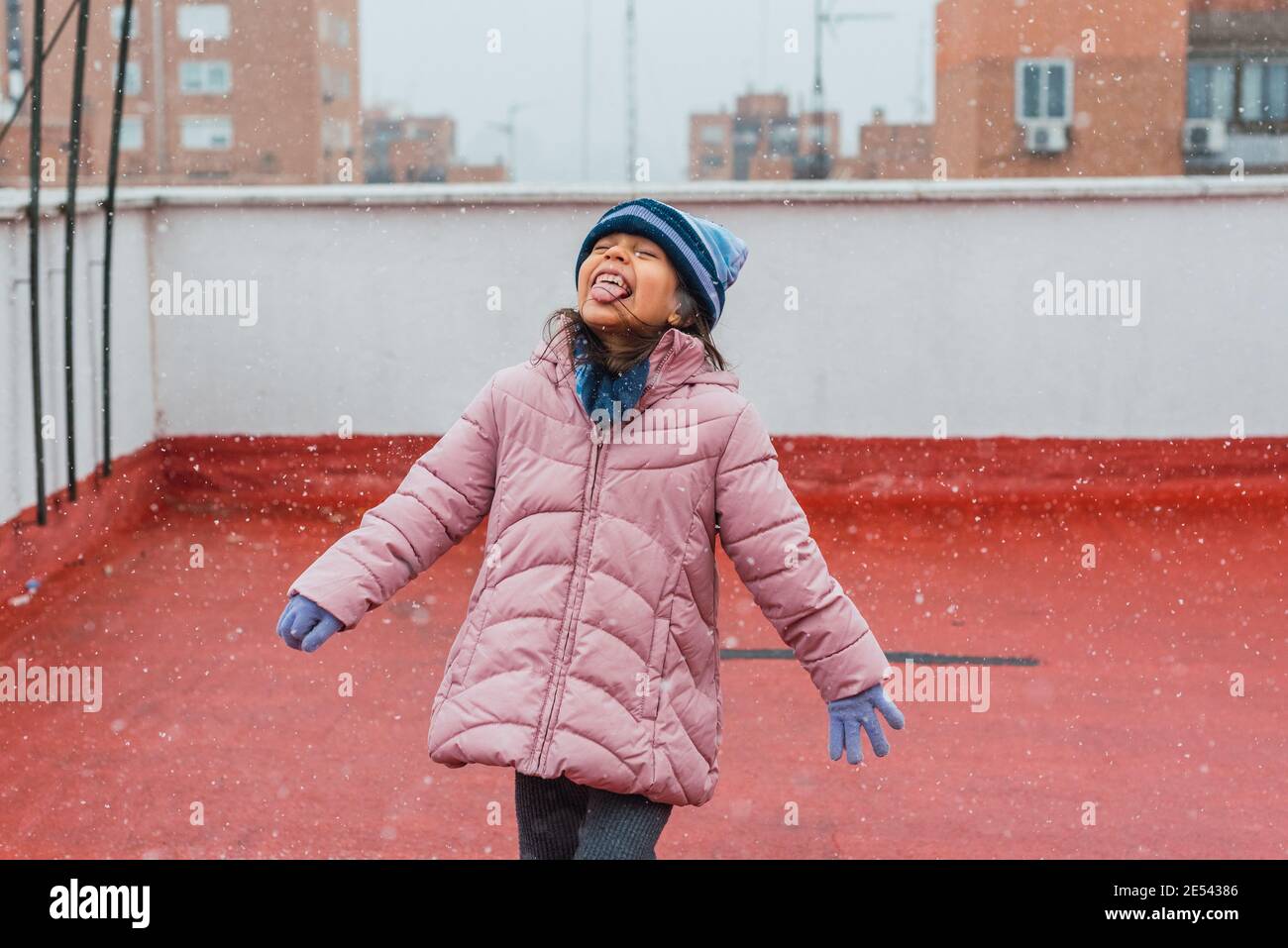 Girl eating snowflakes with her tongue Stock Photo - Alamy