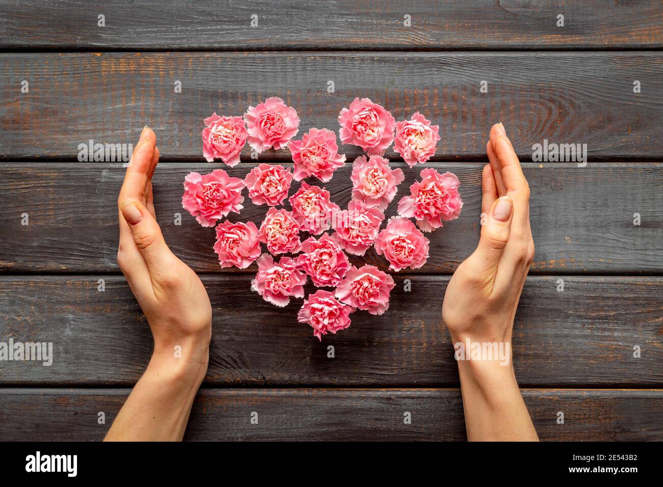 Heart shape of flowers with hands. Valentines Day, wedding or birthday ...