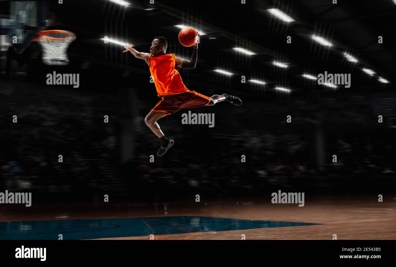 High dunk. African-american young basketball player in action and ...