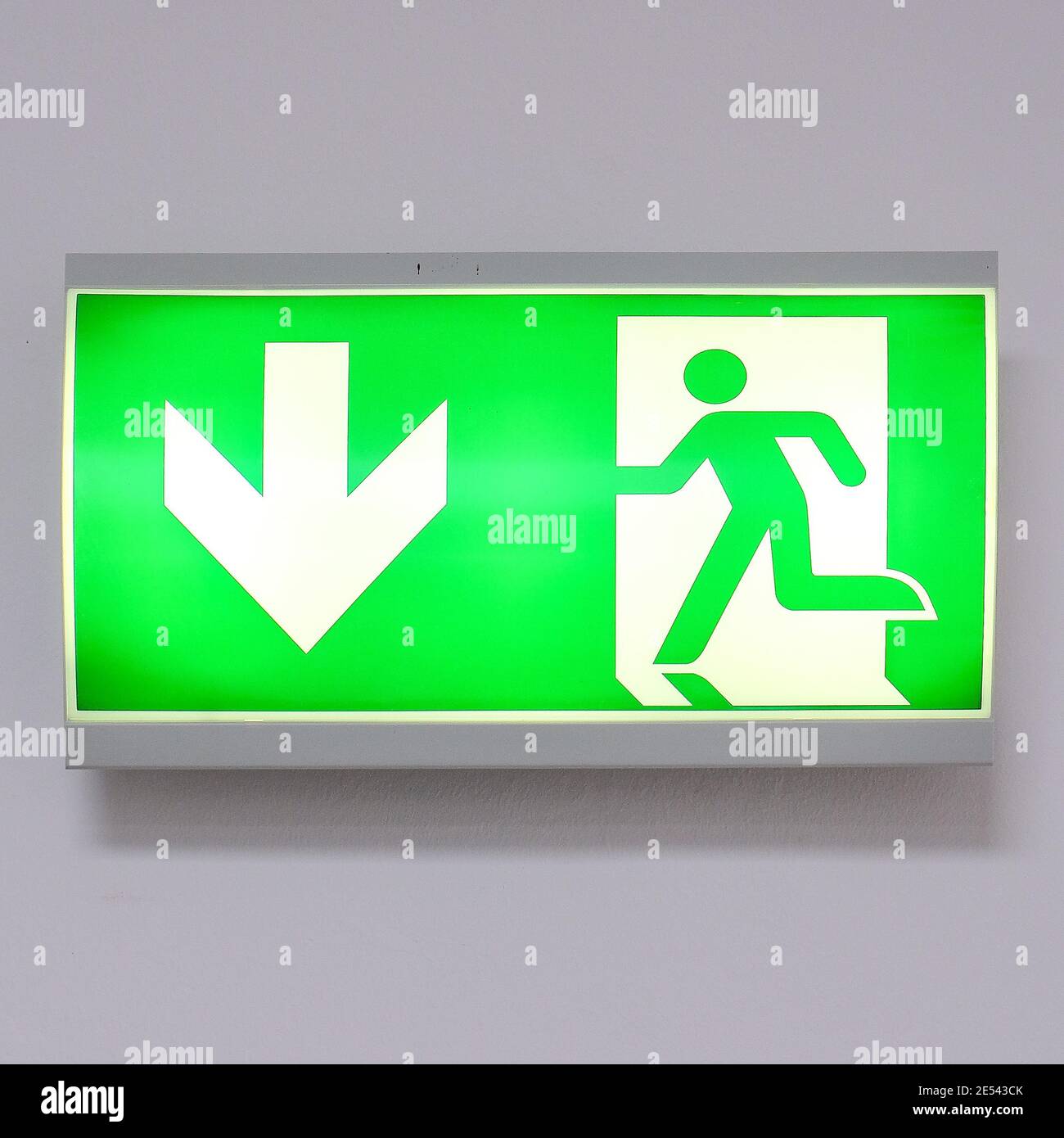 Green alert emergency escape sign lightbox Stock Photo - Alamy