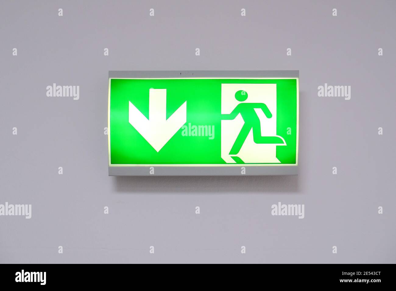 Green alert emergency escape sign lightbox Stock Photo - Alamy