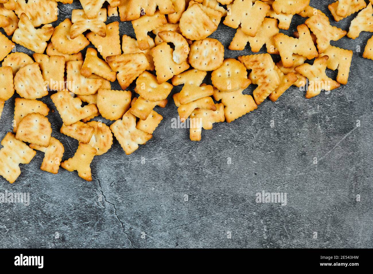 Scattered alphabet crackers on a marble background Stock Photo - Alamy