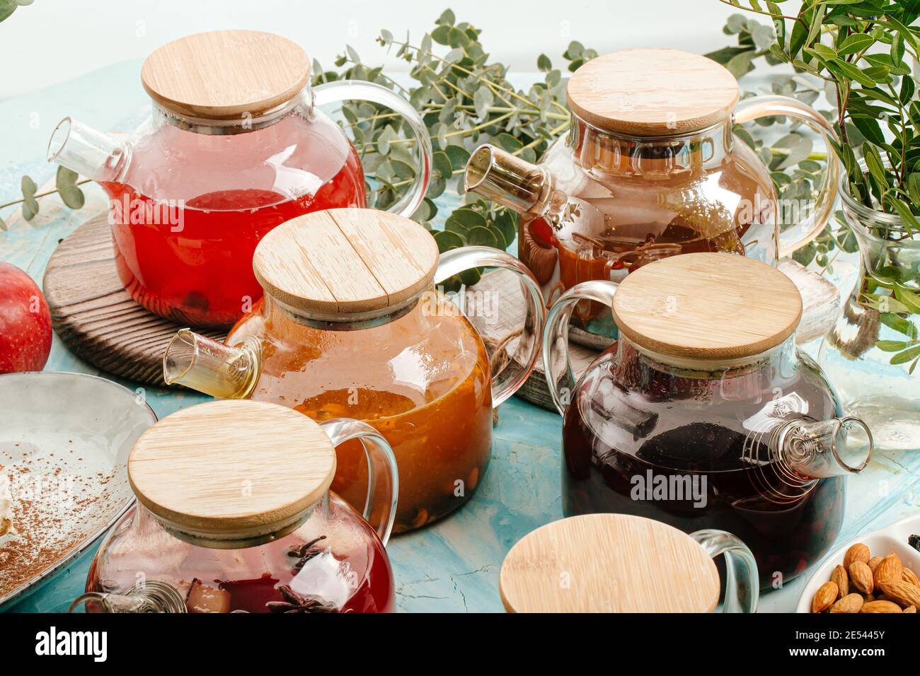 Assorted fruit tea in glass pots on the blue Stock Photo - Alamy