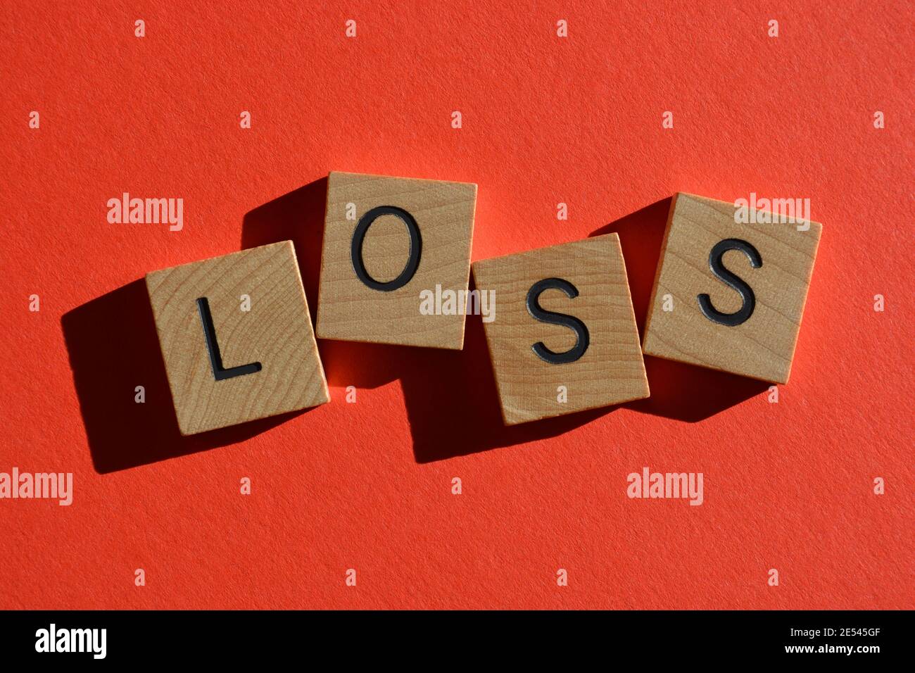 Loss, word in wooden alphabet letters isolated on bright red background ...
