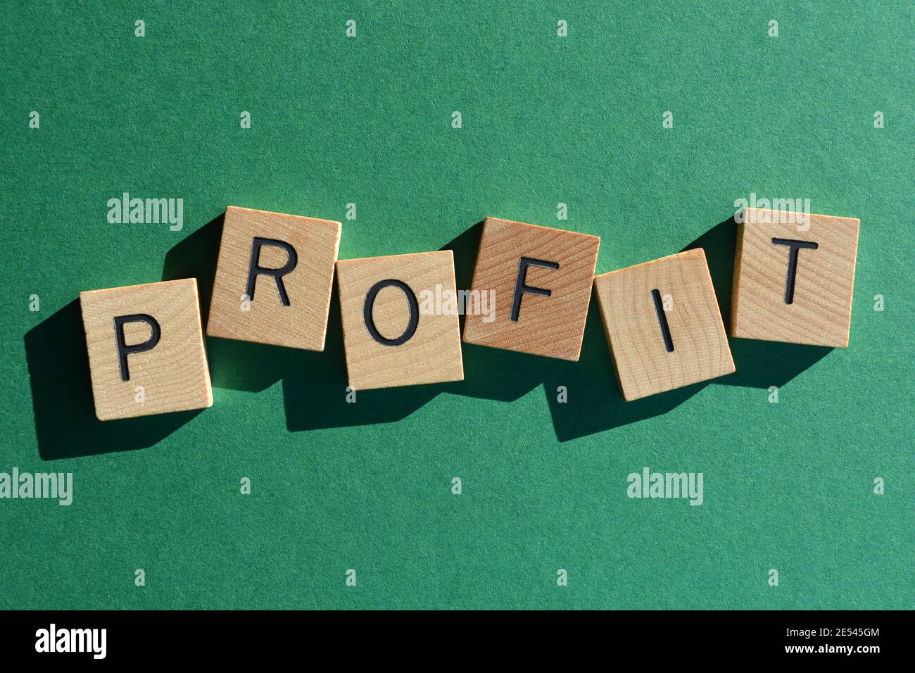 Profit, word in wooden alphabet letters isolated on green background ...