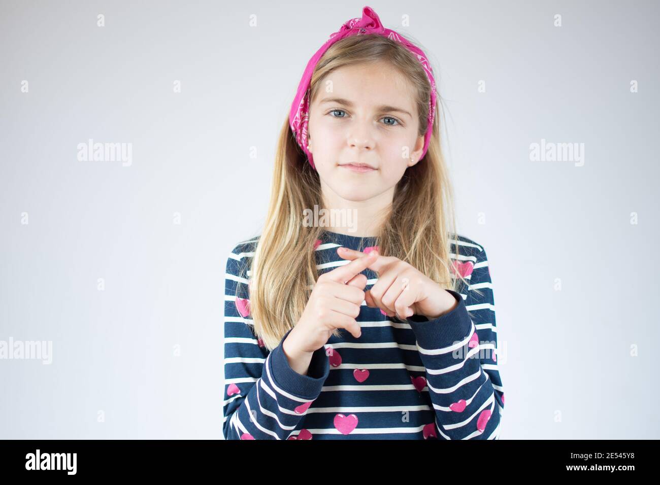 Little girl over white background doing stop sing with fingers of the ...