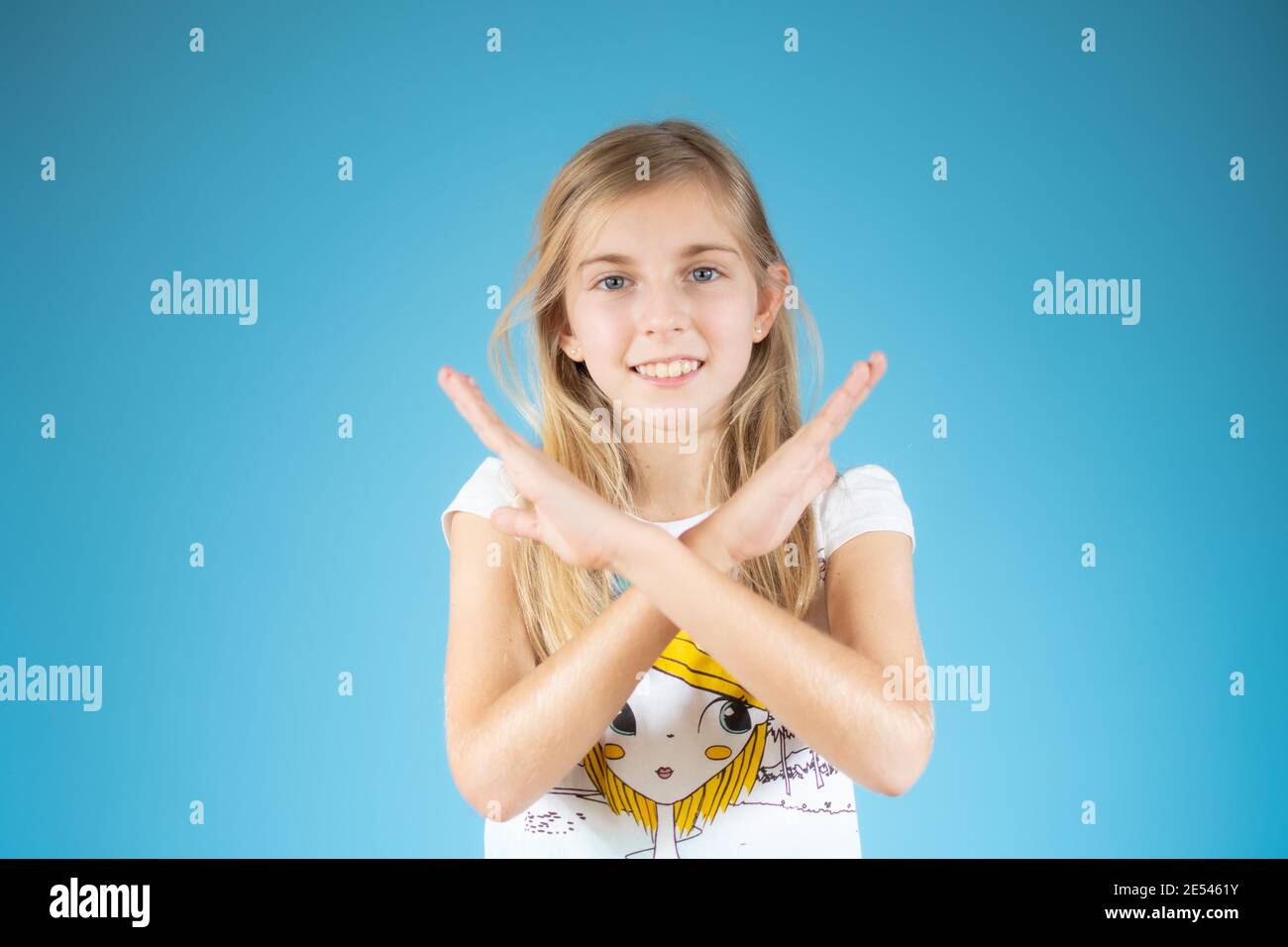 Little girl over white background doing stop sing with arms crossed ...