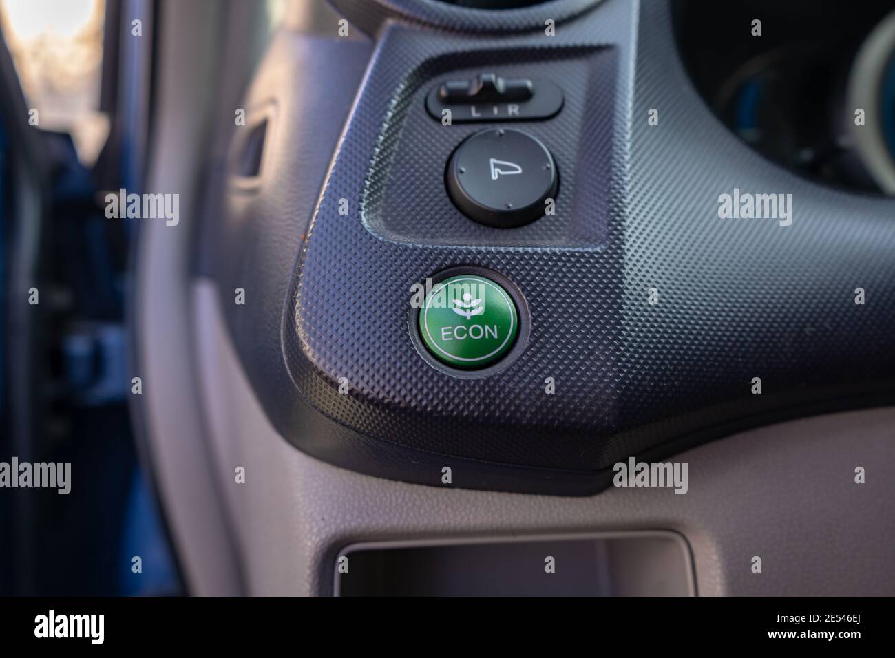 eco button in a hybrid car, switching vehicle to eco mode to save the ...