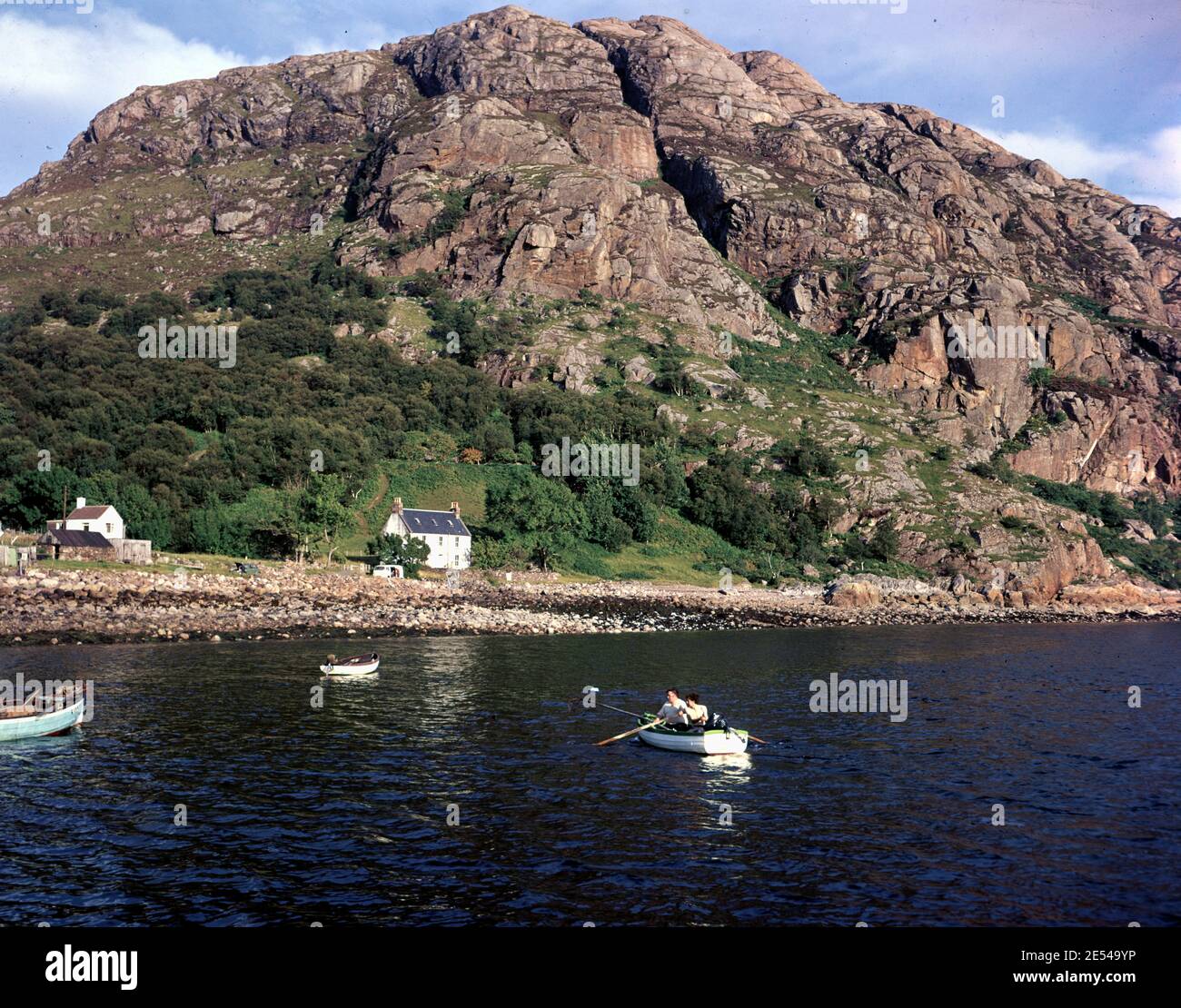 Ross, Scotland. Fishing on Loch Torridon with the tiny hamlet of ...