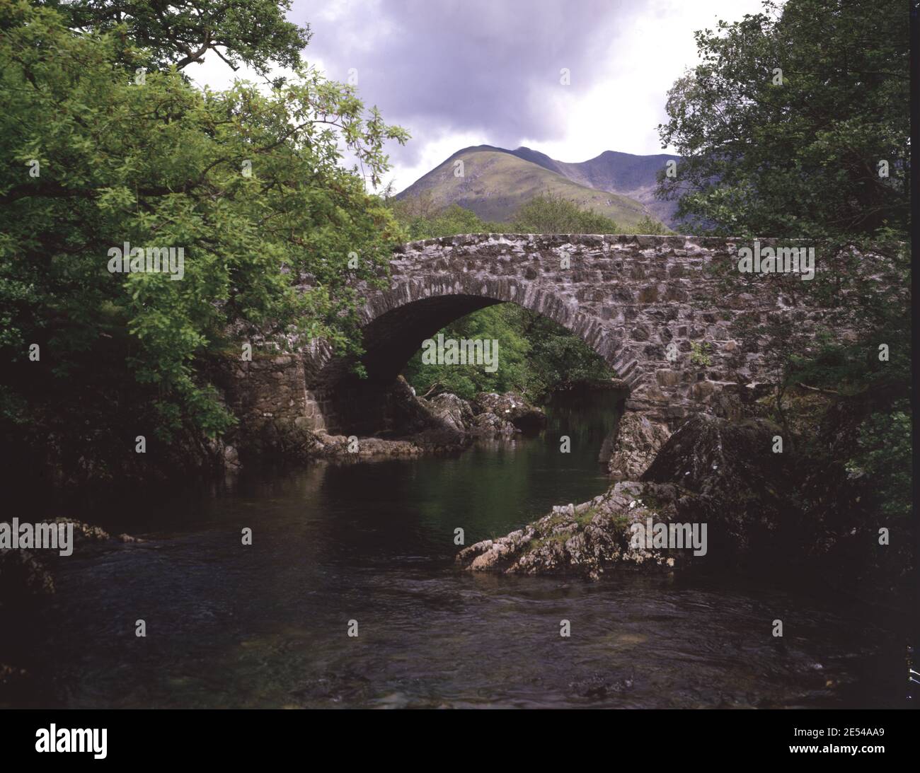 Scotland, Highlands. Bridge over River Strae. With Ben Cruachan's lofty ...