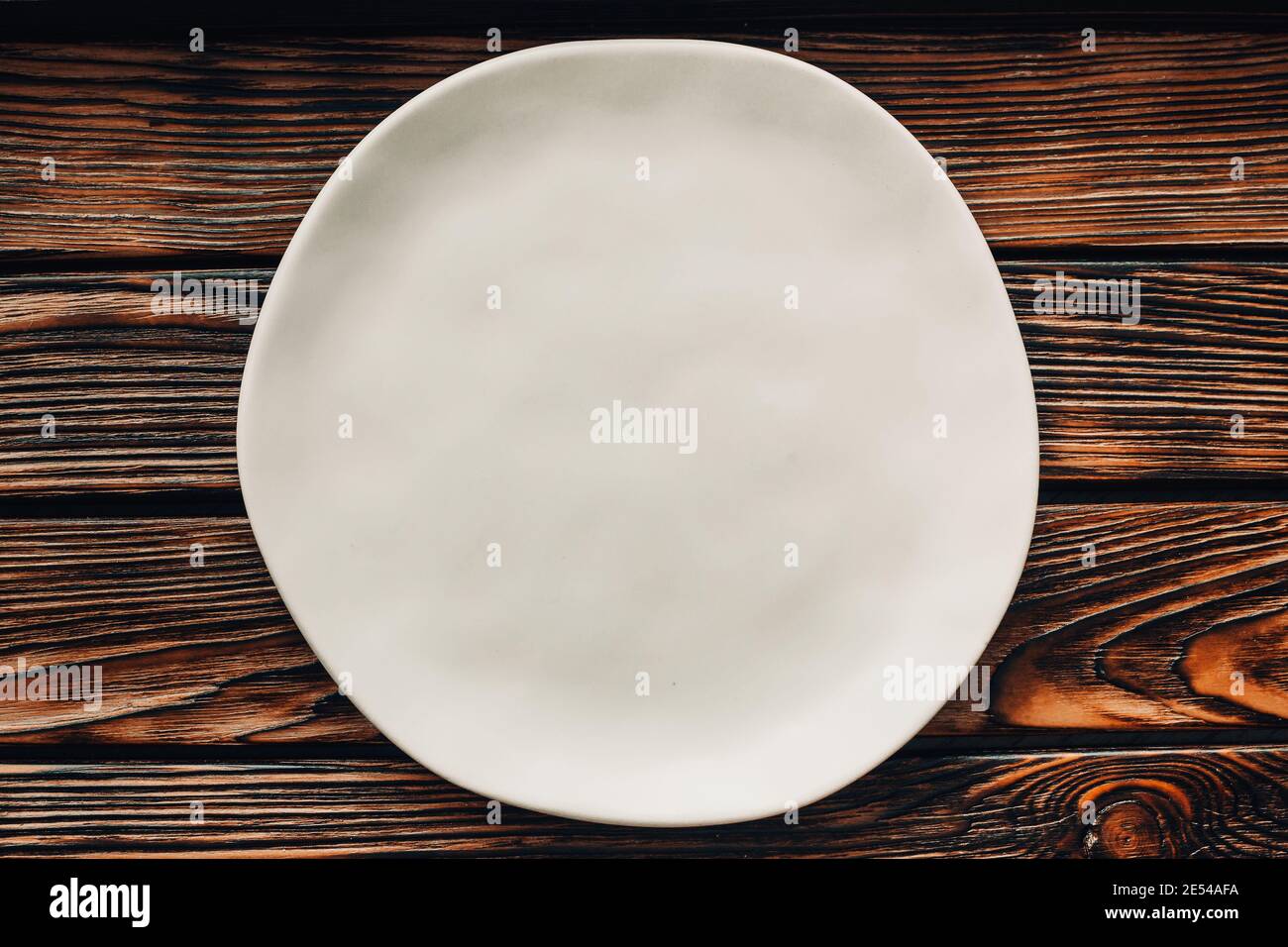 Ceramic plate on a wooden table - custom made rustic dishes - top view ...