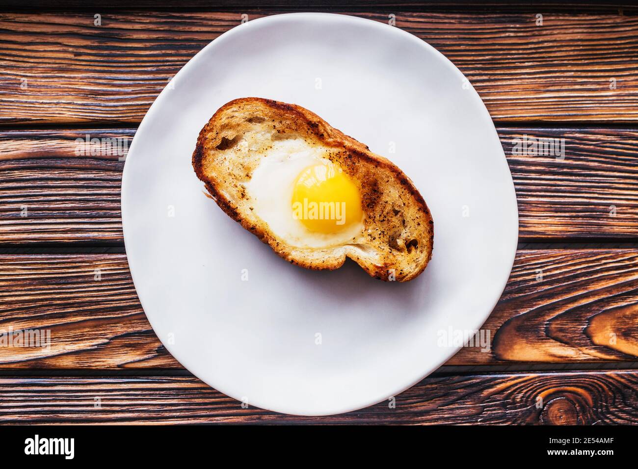 Simple rustic English breakfast - fried bread with egg inside ...