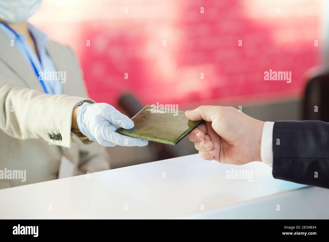 Close-up of man giving his documents for registration at the airport ...