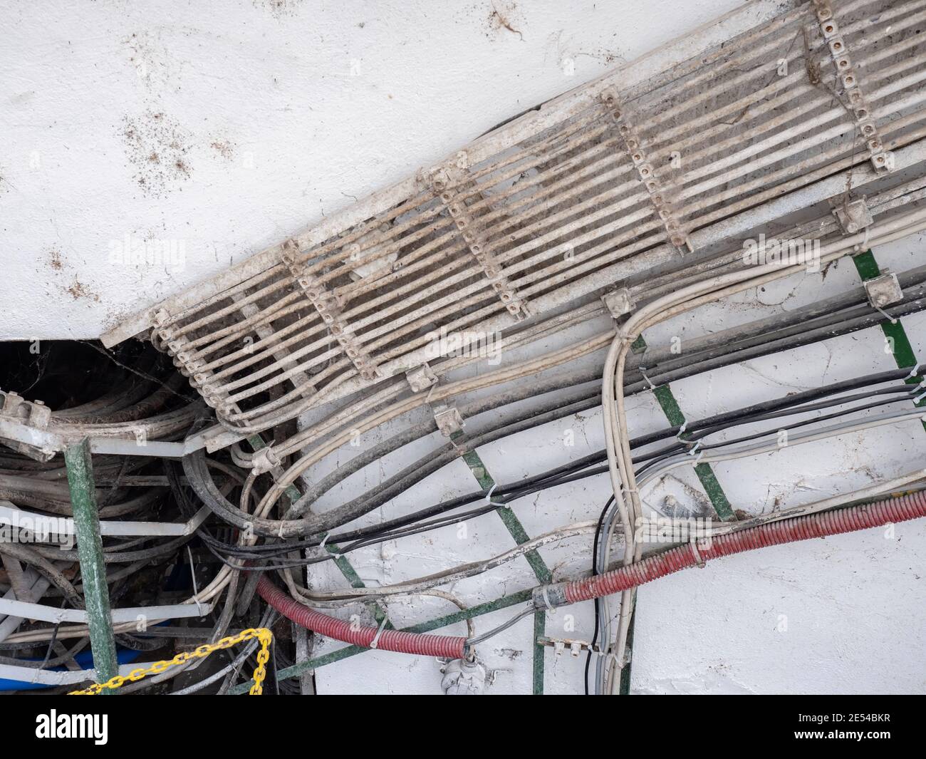 Electric cables. The close up view on lots of cables at a wall in a ...
