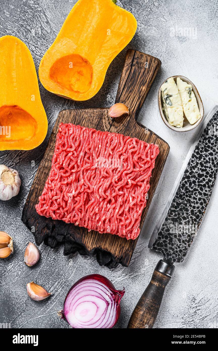 Raw mince meat, pumpkin with garlic and onion. White background. Top ...