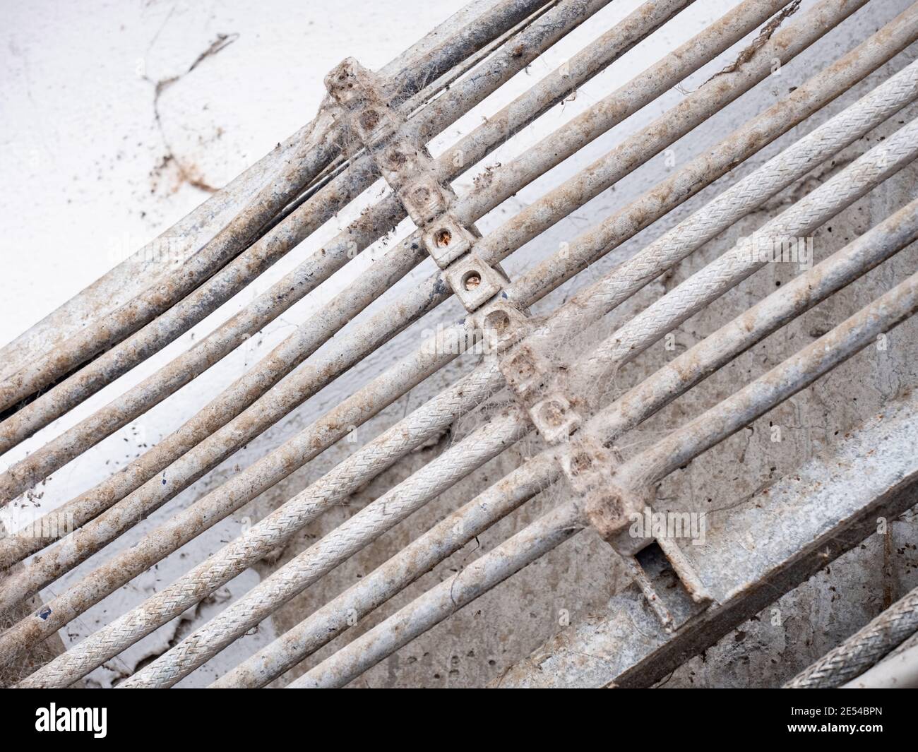 Electrical conduits and air ducts on the wall. Metal conduit with dusty ...
