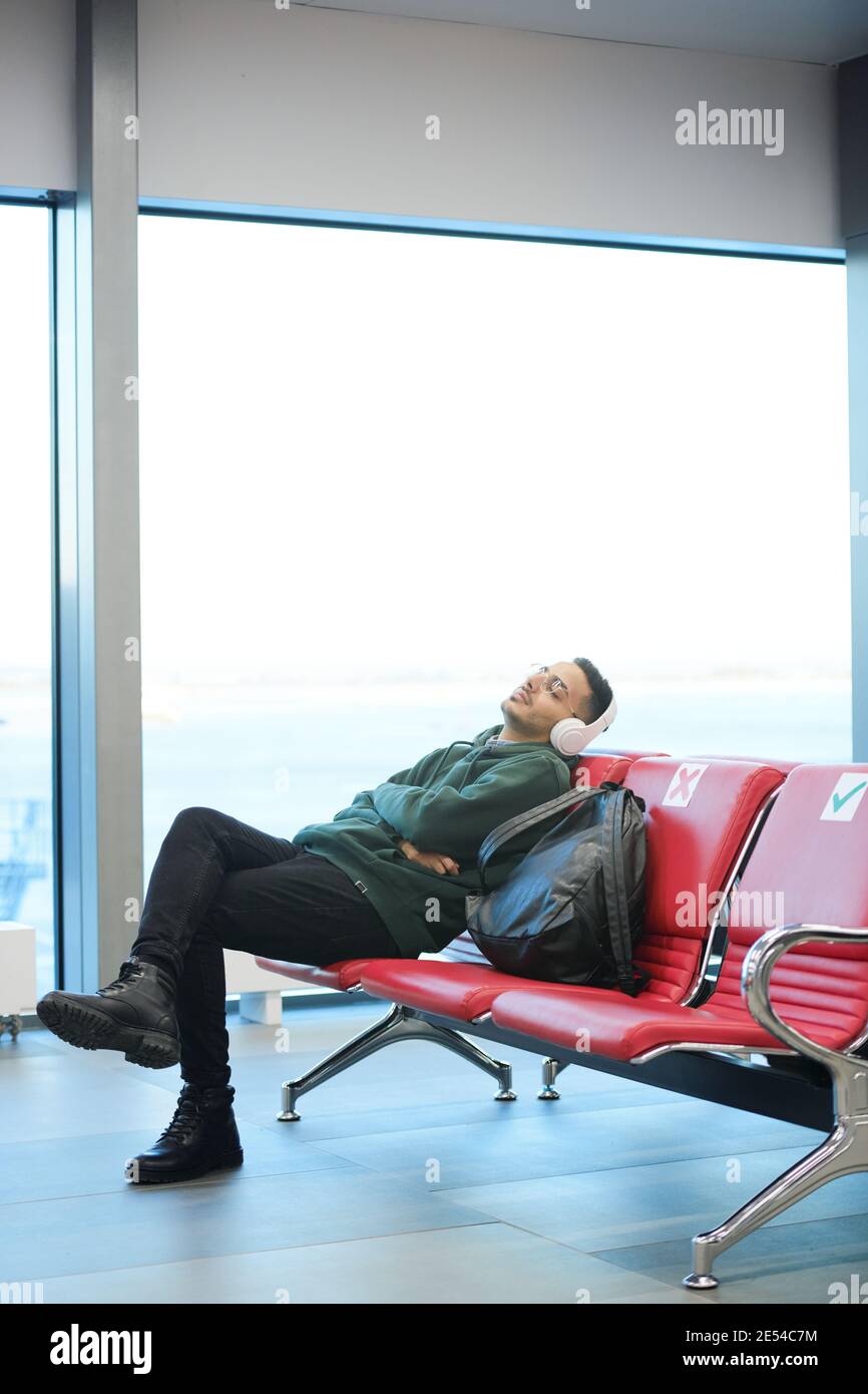 Man sleeping on chair in waiting room of the airport terminal Stock ...