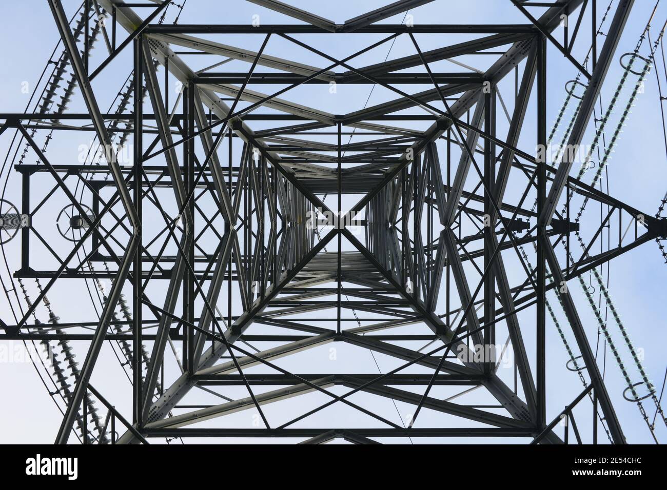 Electricity pylon from directly underneath with blue sky overhead ...
