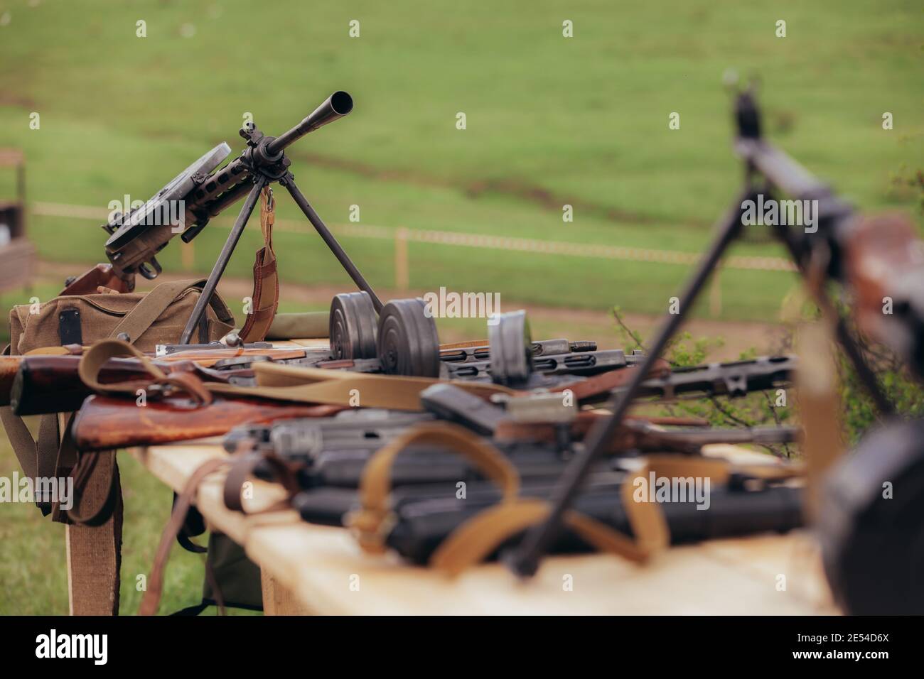Two Diagterev submachine guns stand opposite each other on a table ...