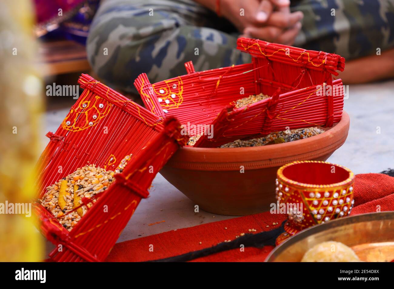 Closeup of red-colored equipment used in Indian traditional rituals ...