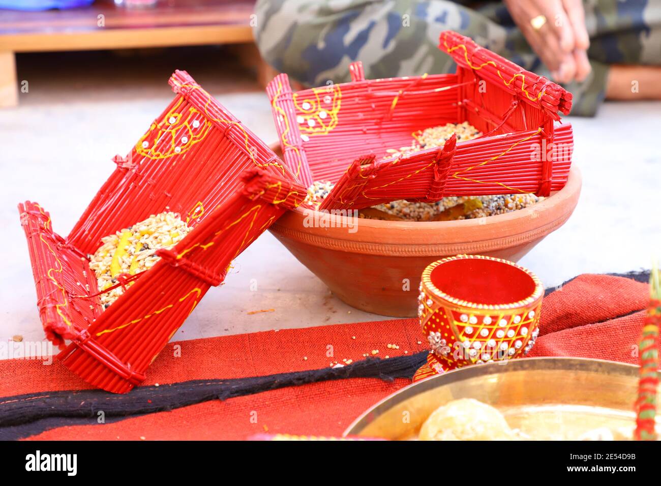 Closeup of red-colored equipment used in Indian traditional rituals ...