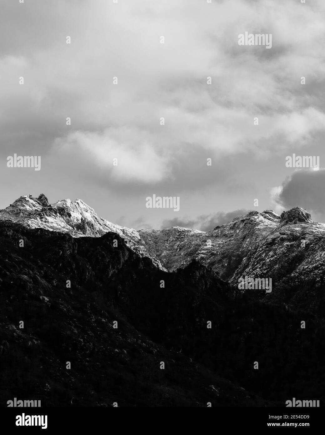 A grayscale vertical shot of snowy mountains Stock Photo - Alamy
