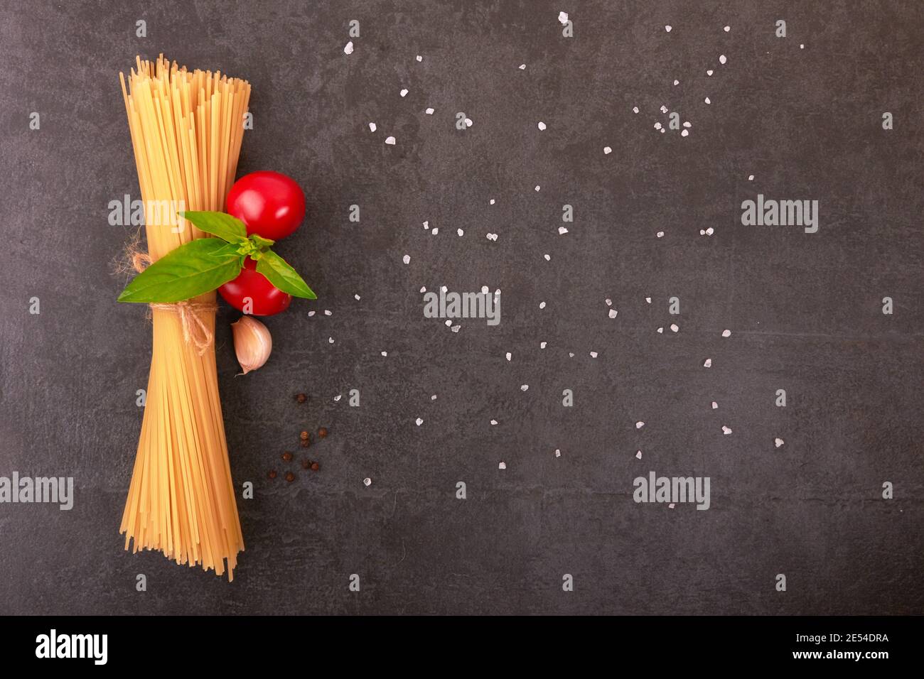 spaghetti on a stone black background with basil Stock Photo - Alamy