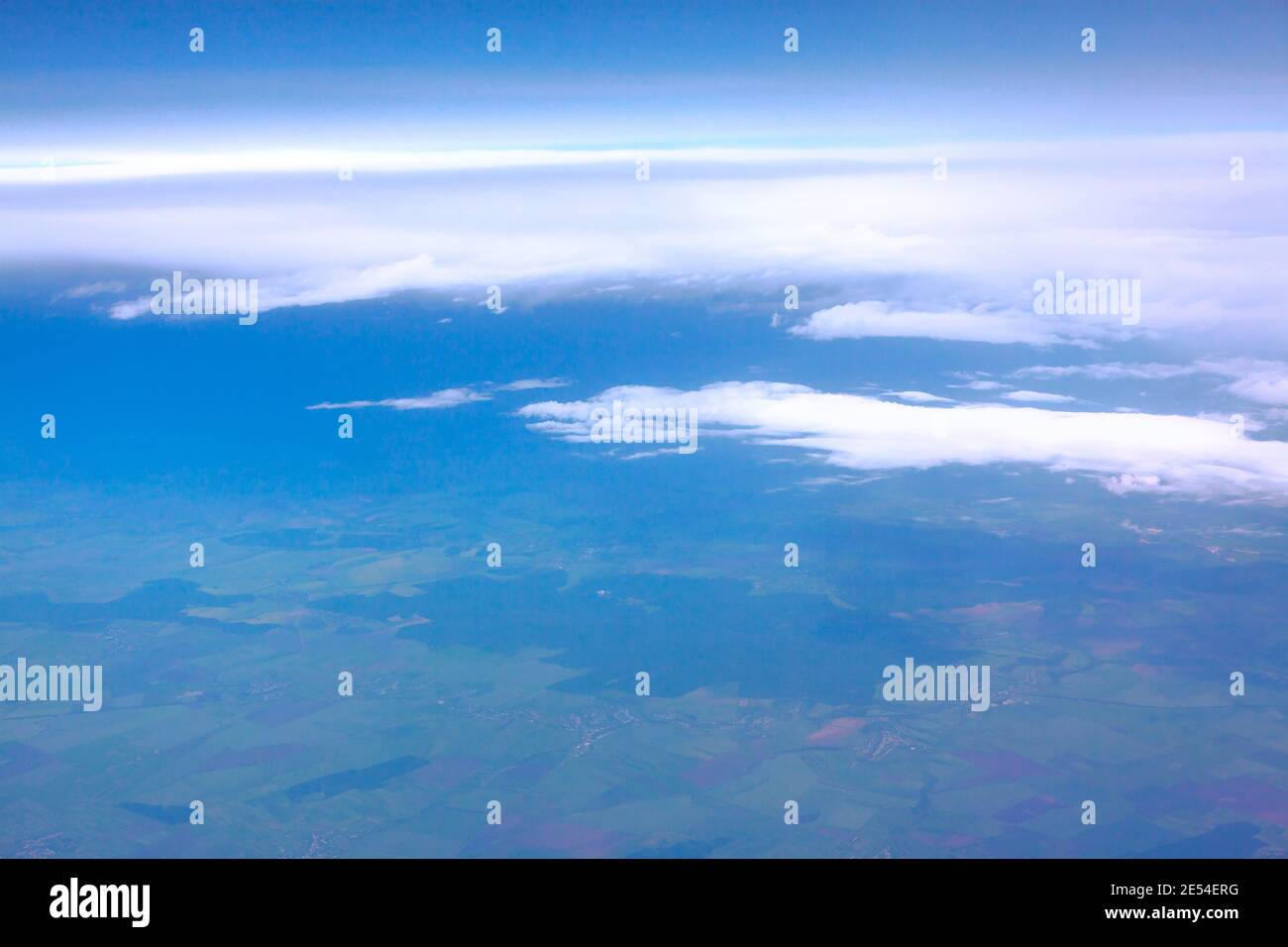 Flying over the green fields . Earth view from the airplane window ...