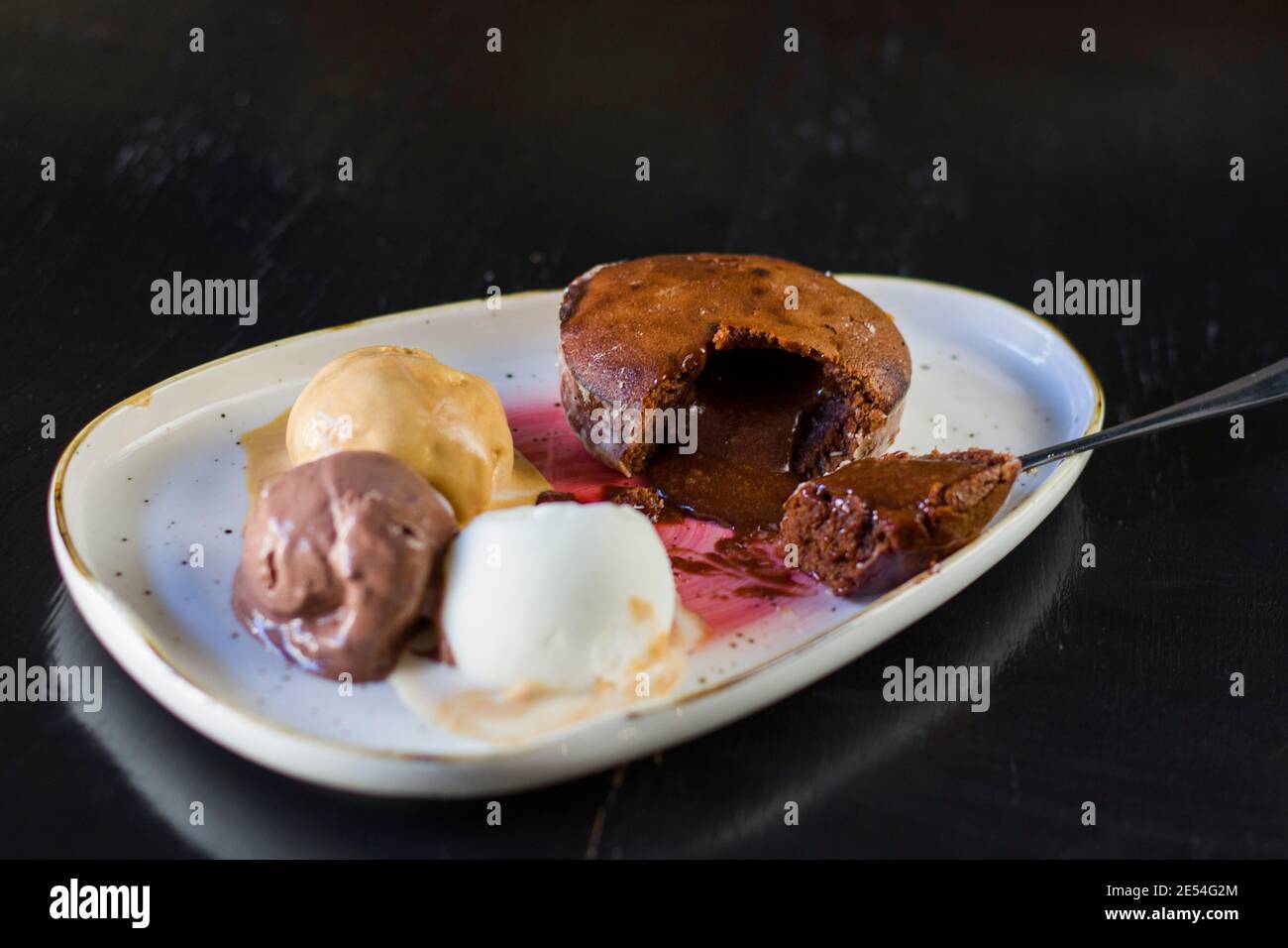 Volcano dessert with ice cream, souffle and baked pastry on the plate ...