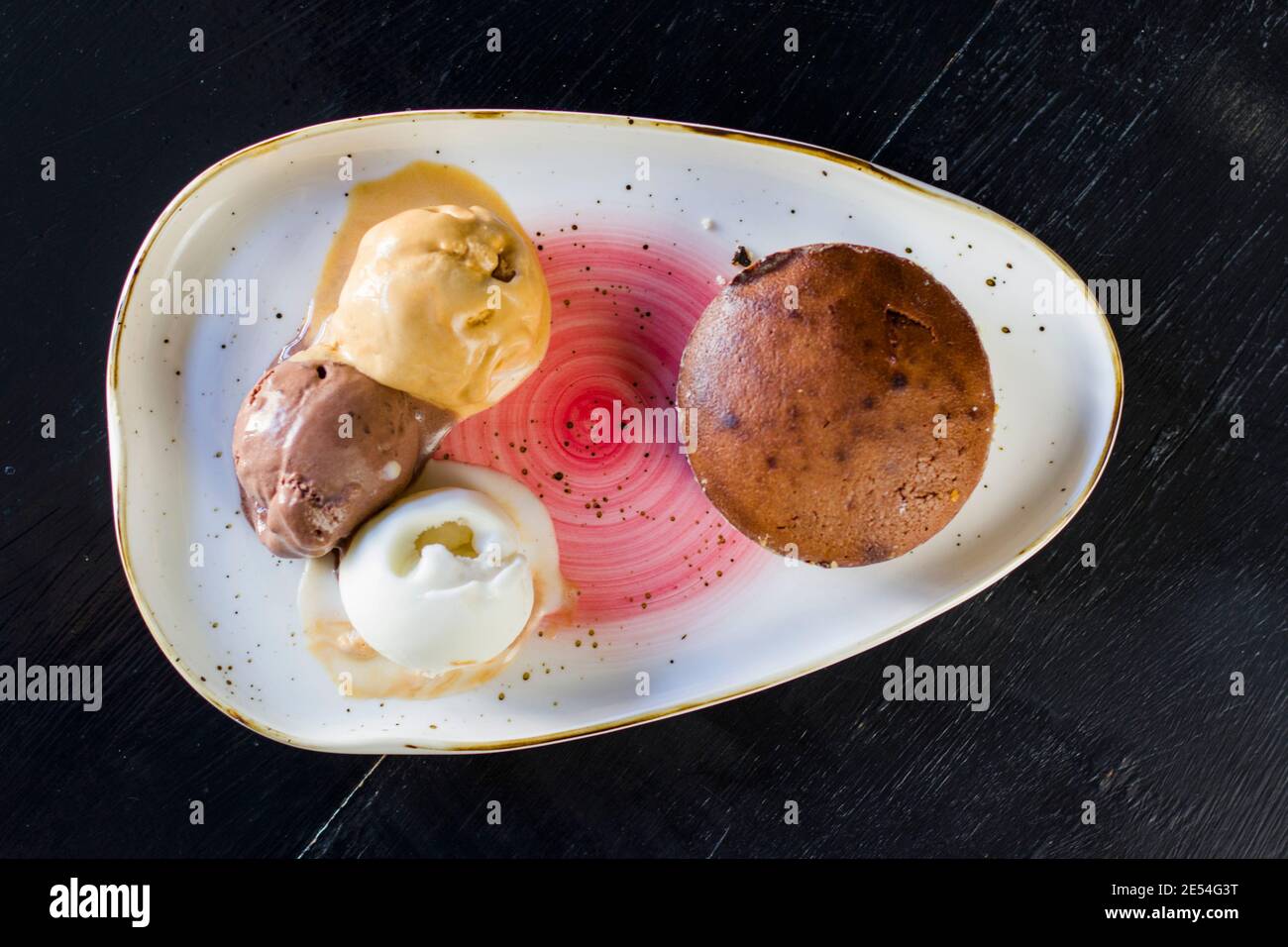 Volcano dessert with ice cream, souffle and baked pastry on the plate ...