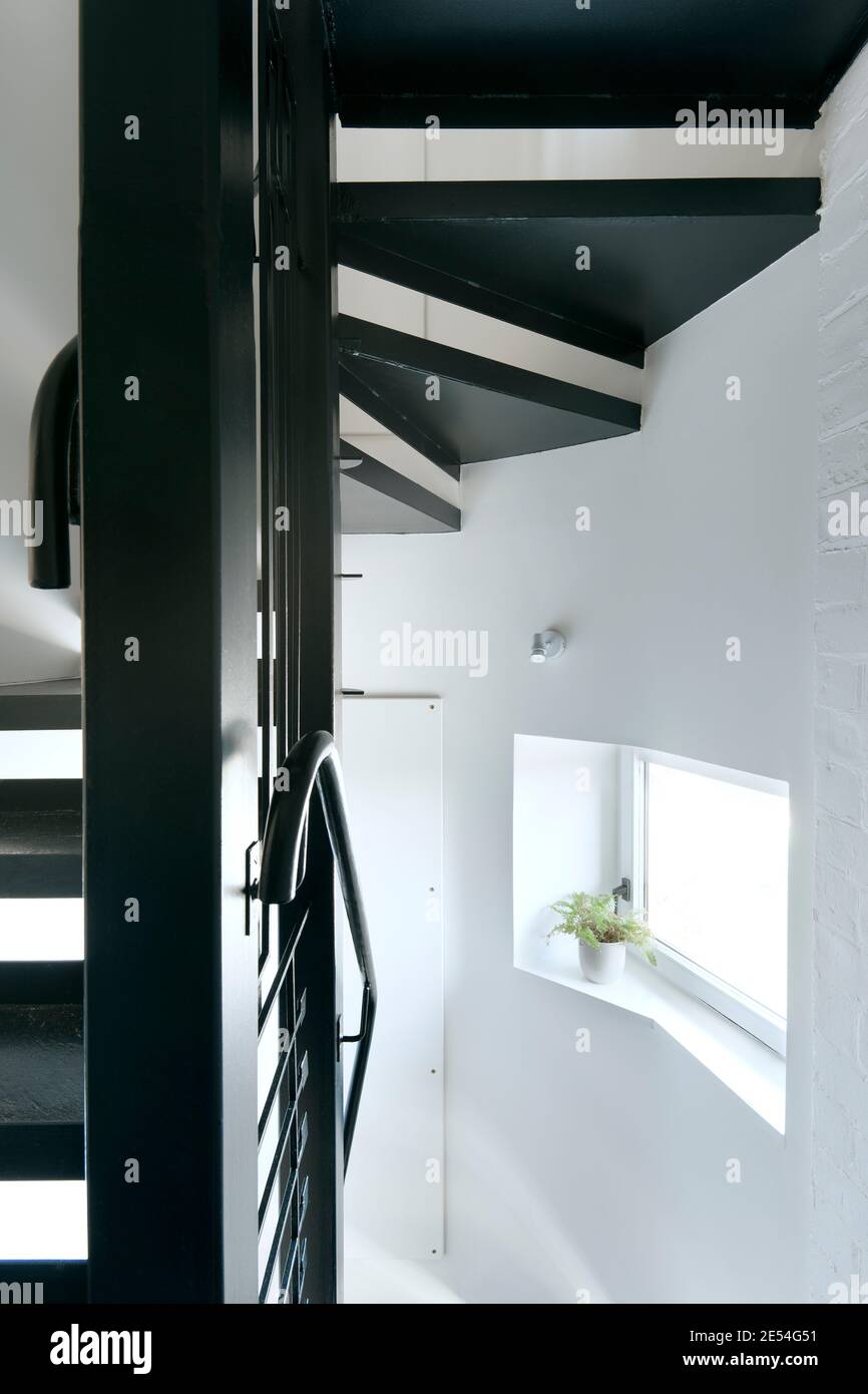 Looking under the steel spiral staircase to a side window - Architect ...