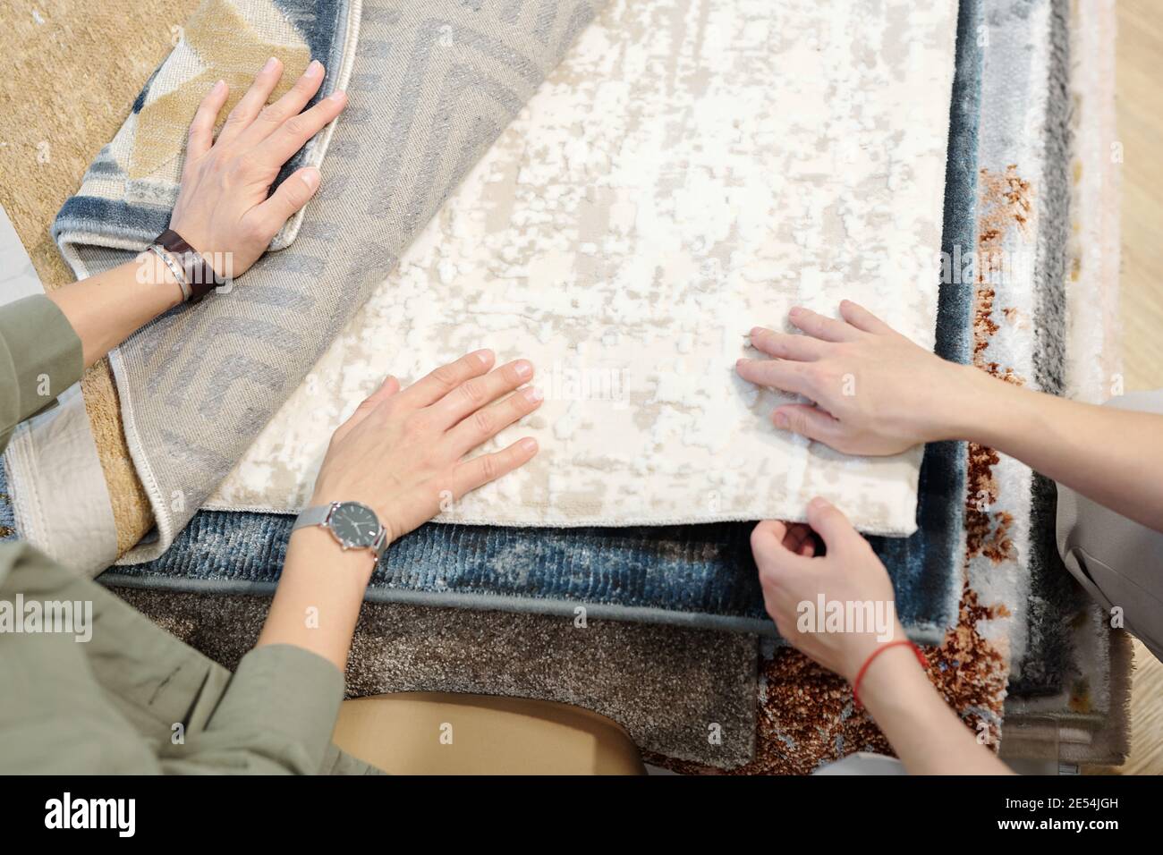 Hands of young female client and designer of contemporary studio of ...