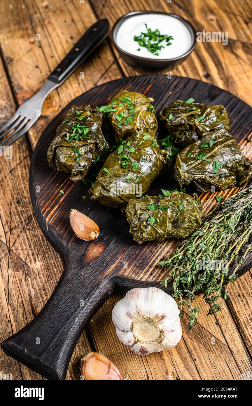 Traditional georgian dolma in grape leaves. wooden background. Top view ...