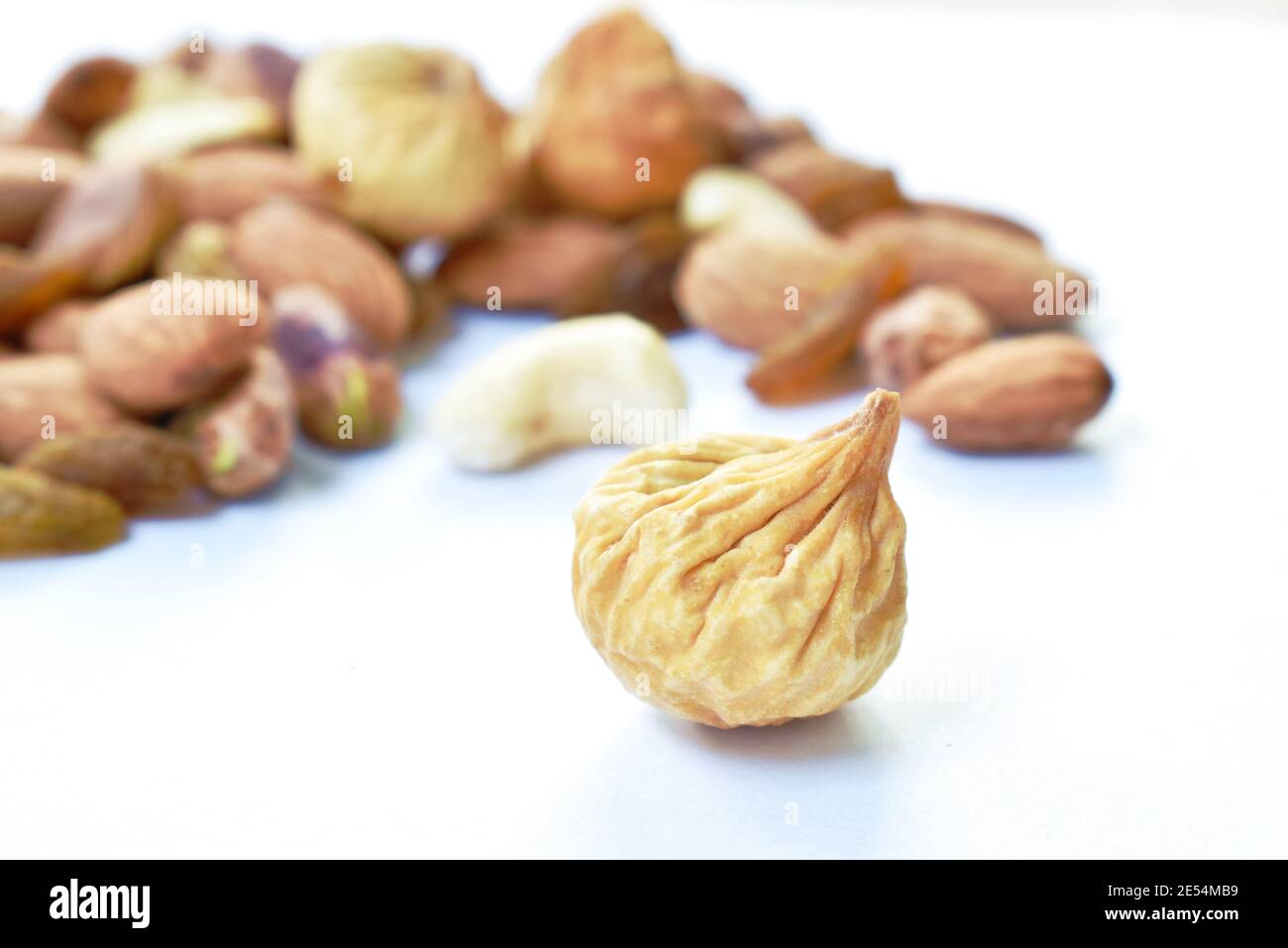 mixed nuts and dry raisin with fig on white background Stock Photo - Alamy