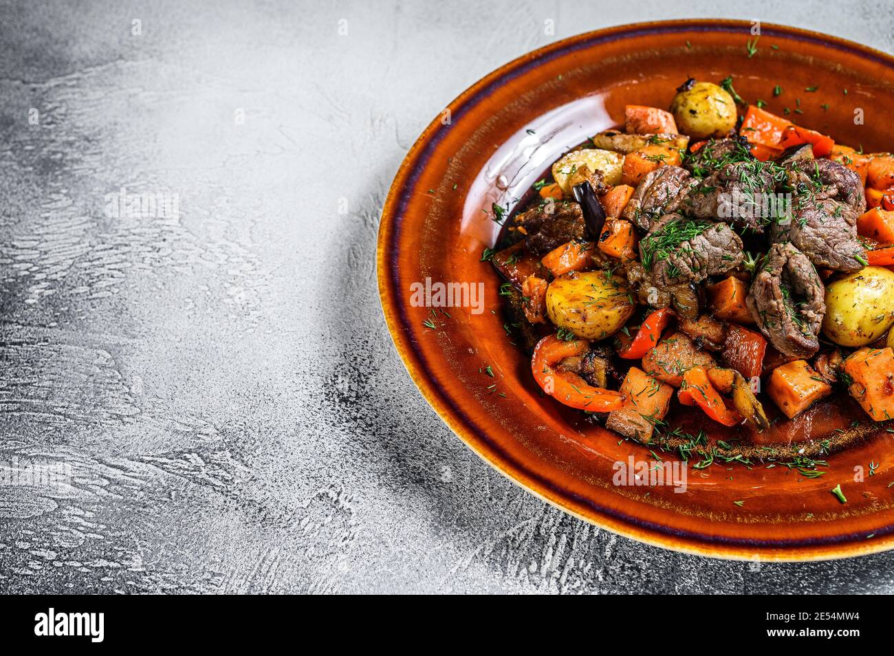 Meat stew, goulash on a plate. White background. Top view. Copy space ...
