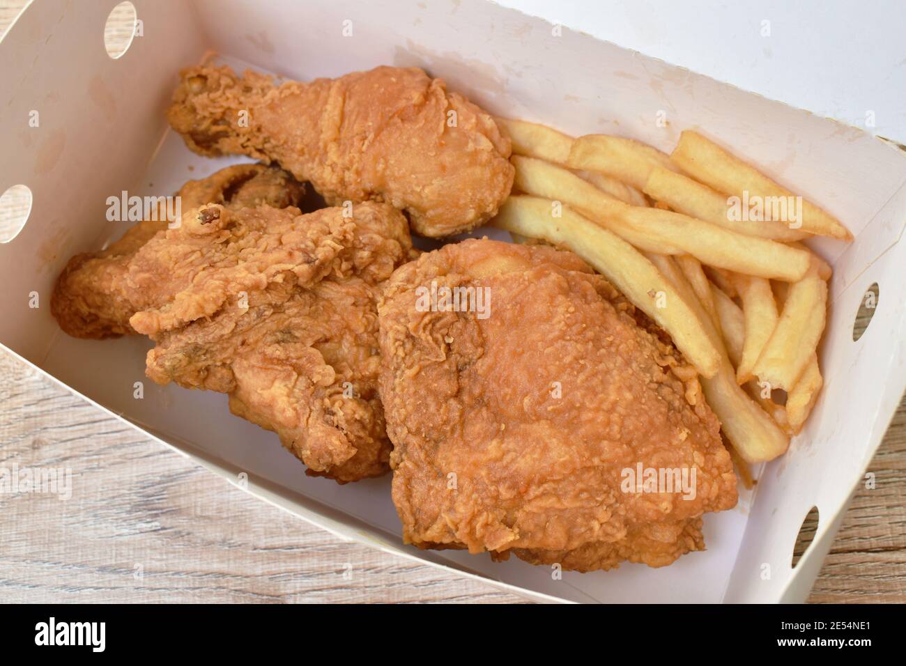 fried chicken and French fries in paper box packing on table Stock ...