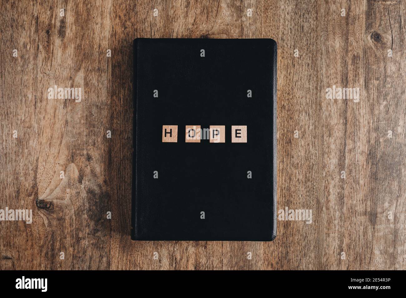Hope in block letters on a bible on a wooden table.Top view flat lay ...