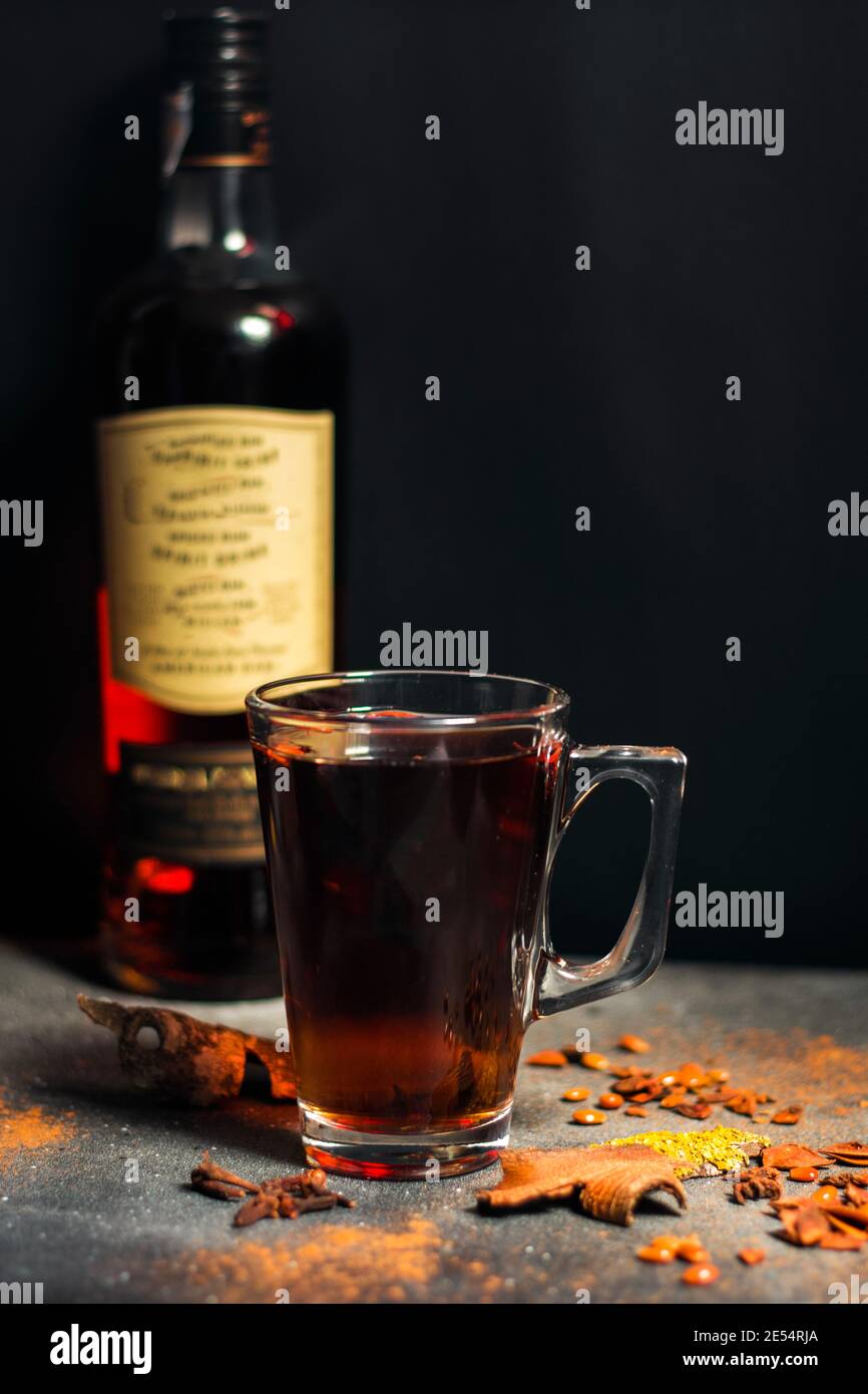Rome with tea, Grog on the black background Stock Photo - Alamy