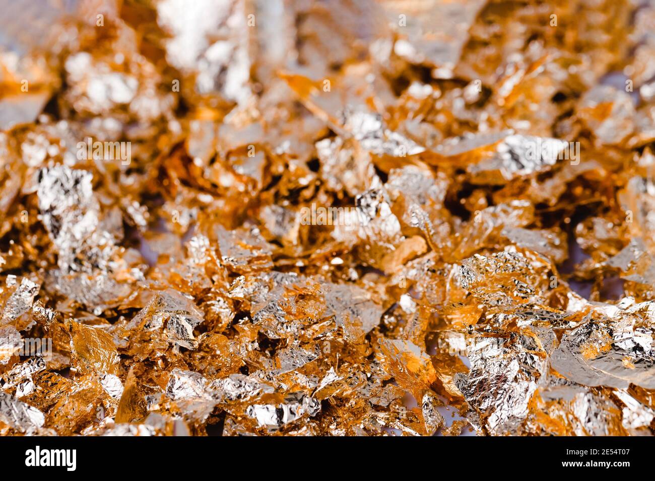 Gold foil flakes shiny textured background Stock Photo - Alamy