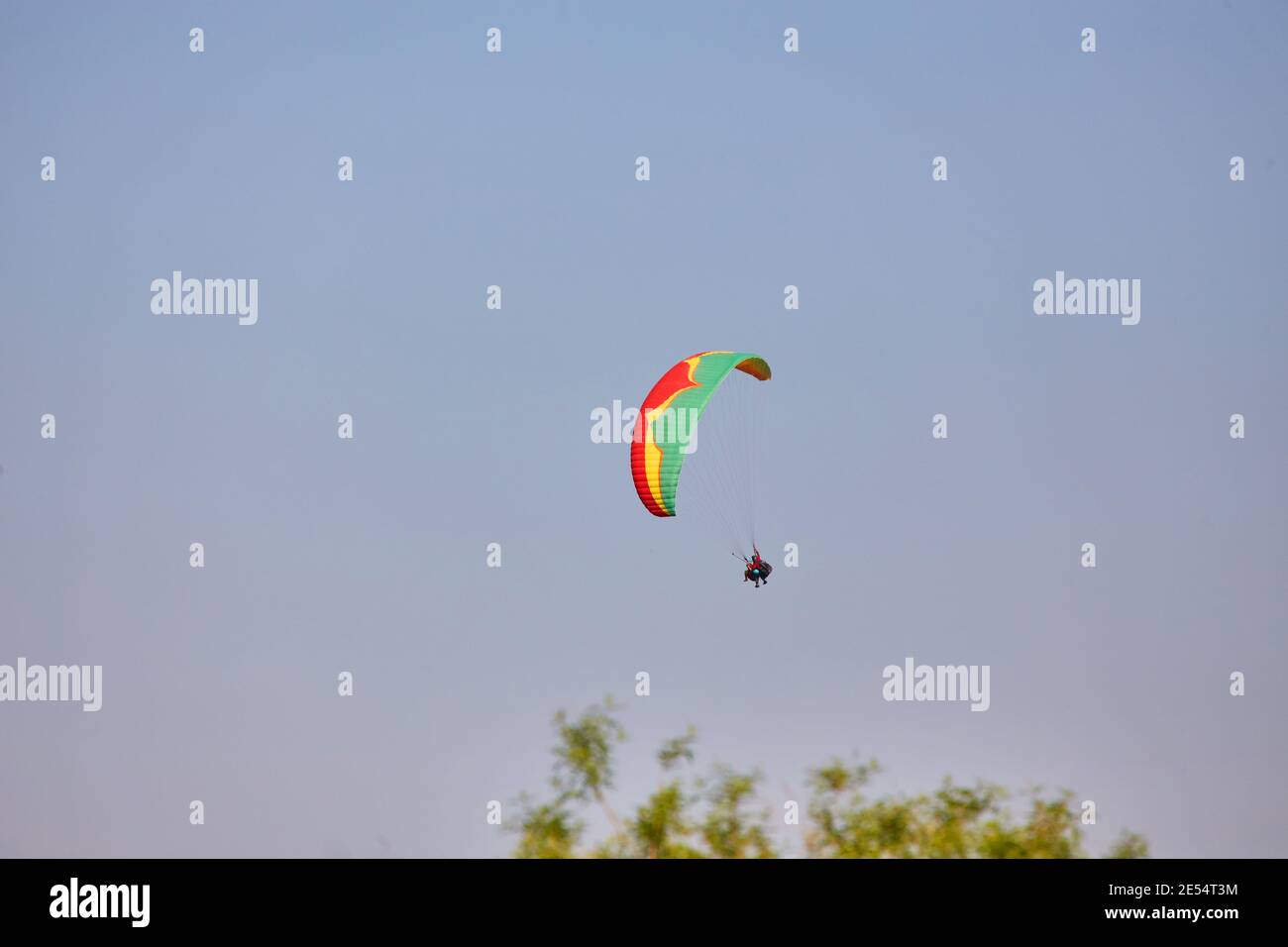 Paragliding in the sky. Paraglider flying in bright sunny day ...