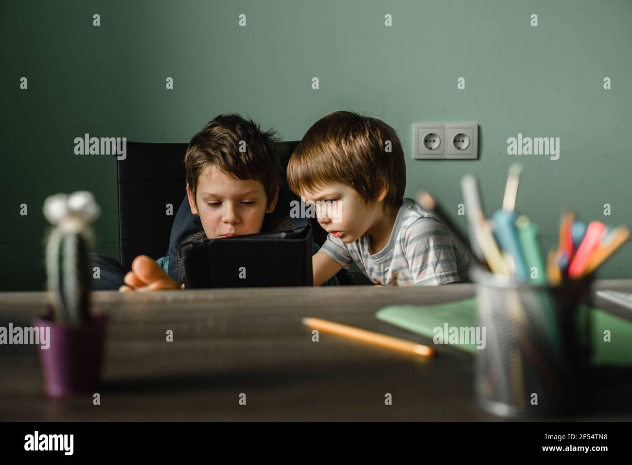 Children playing tablet at home, growing up with technology Stock Photo ...