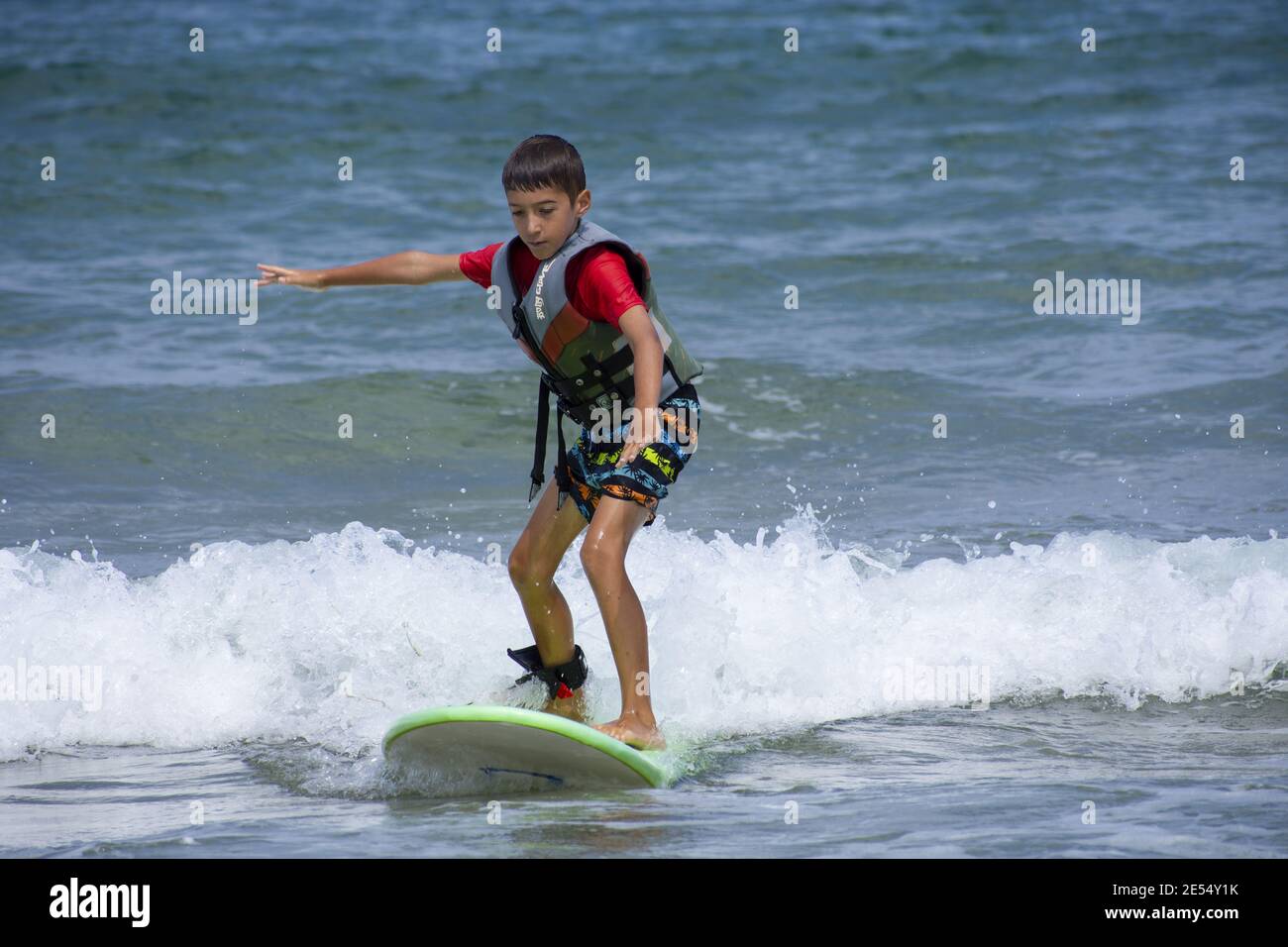 Happy surfer boy at surfboard ride on sea wave Stock Photo - Alamy