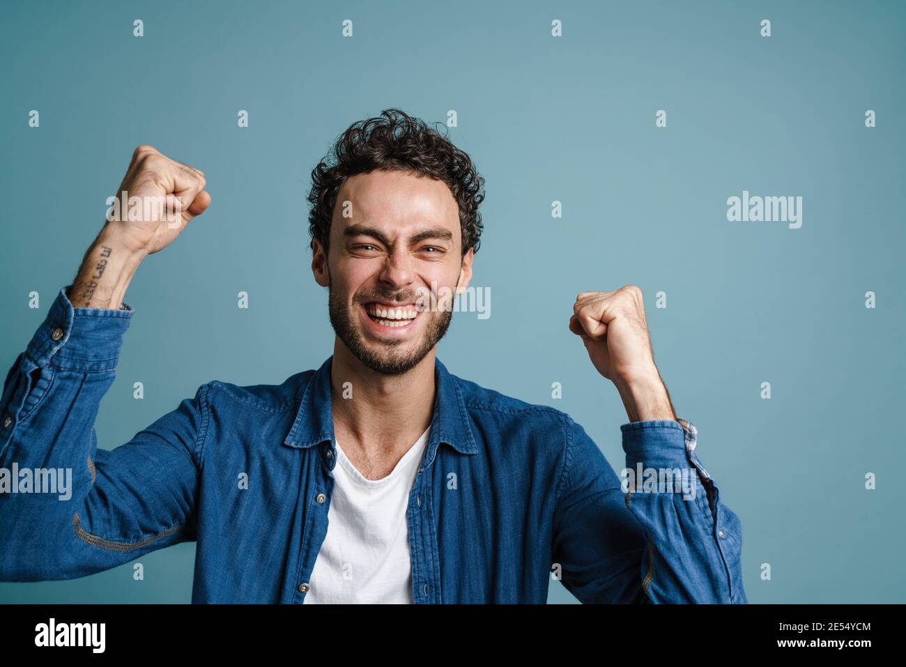 Happy young man celebrating hi-res stock photography and images - Alamy