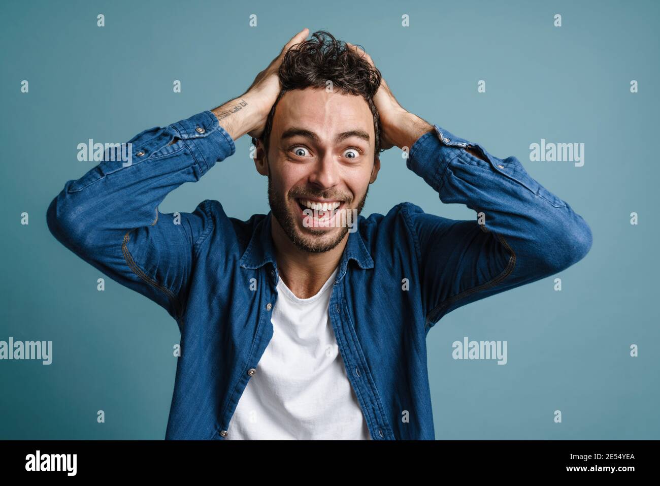 Happy young man celebrating hi-res stock photography and images - Alamy